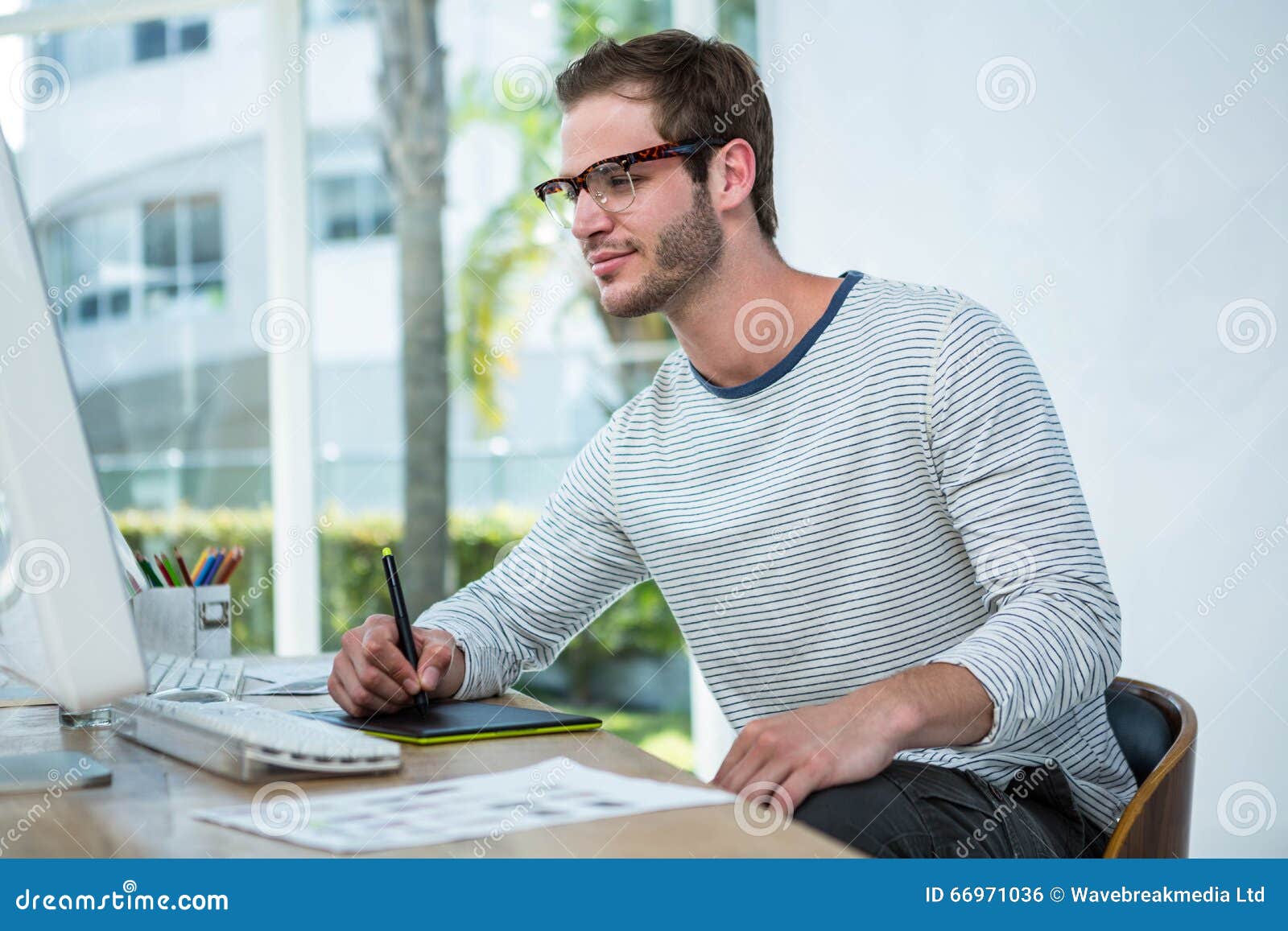 Handsome Man Working on Computer and Taking Notes Stock Photo - Image ...