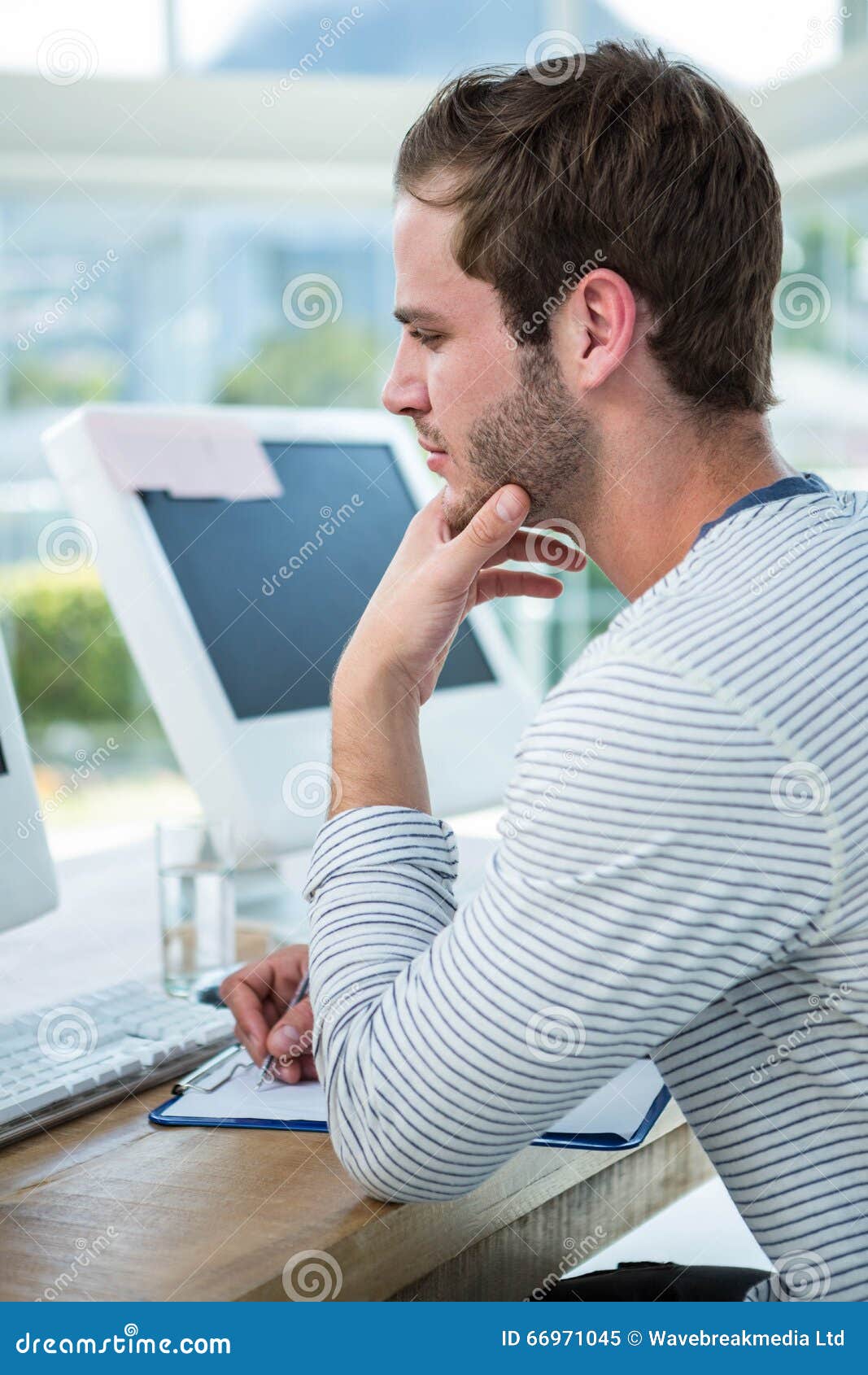 Handsome Man Working on Computer and Taking Notes Stock Image - Image ...
