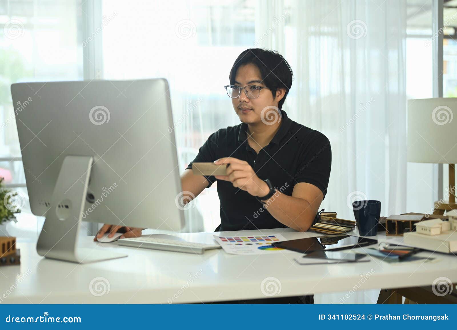 Handsome Man Working on Project at Desk Surrounding with Several ...