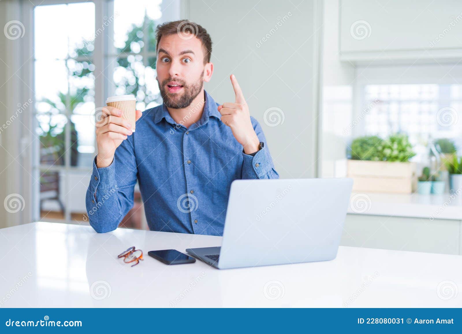 Handsome Man Working Using Computer Laptop and Drinking a Cup of Coffee ...