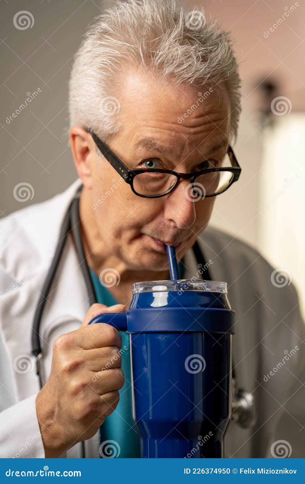 Handsome Mature Doctor Drinking Water from a Cantine Stock Photo ...