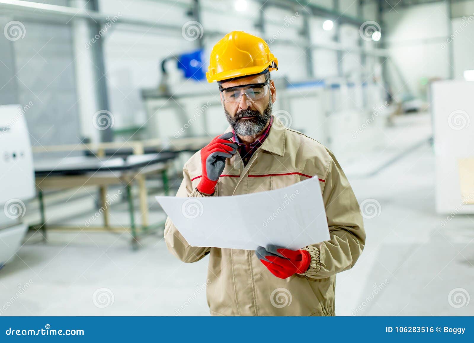 Handsome Mature Engineer Looking at Plan in the Factory Stock Photo ...