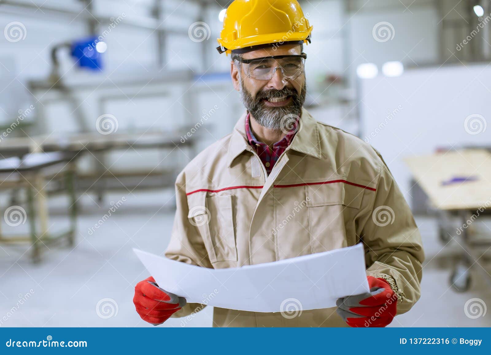 Handsome Mature Engineer Looking at Plan in the Factory Stock Photo ...