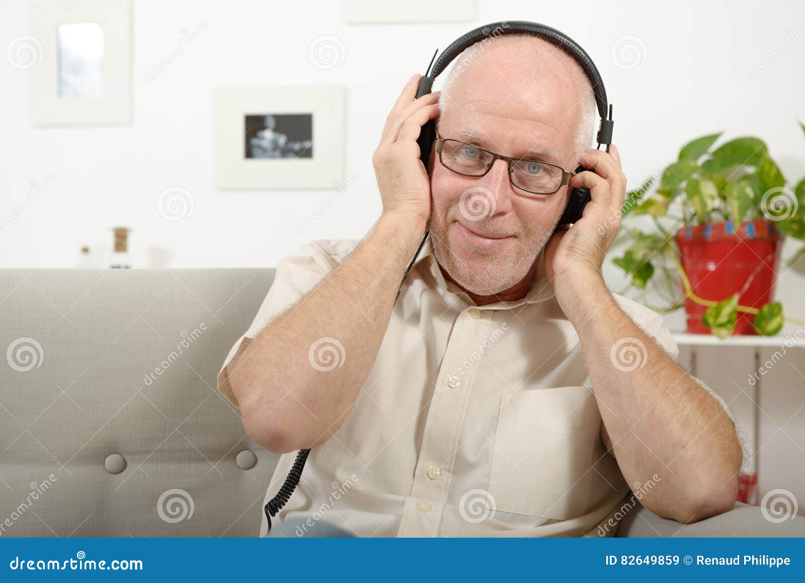 Handsome Mature Man Listening To Music With Headphones Stock Image