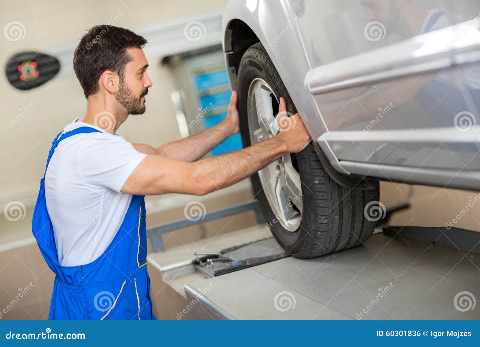 Handsome Mechanic Changing a Tire Stock Photo - Image of change ...