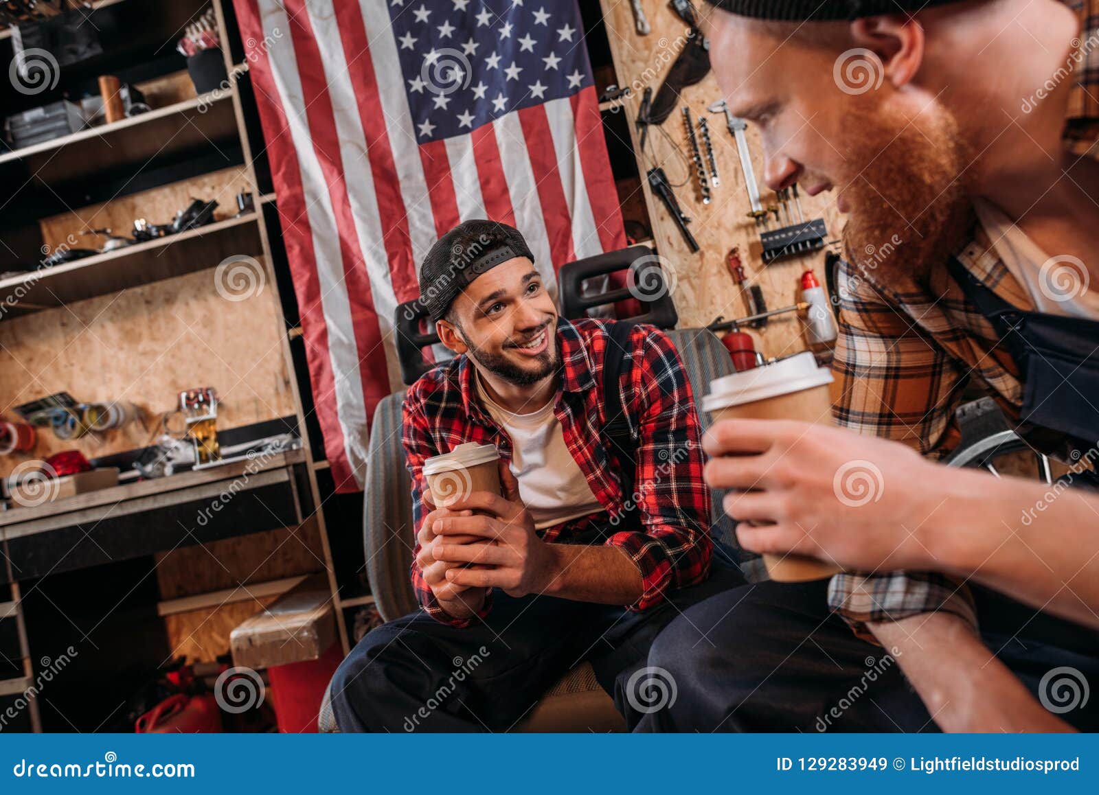 Handsome Mechanics Drinking Coffee from Disposable Cups on Break Stock ...