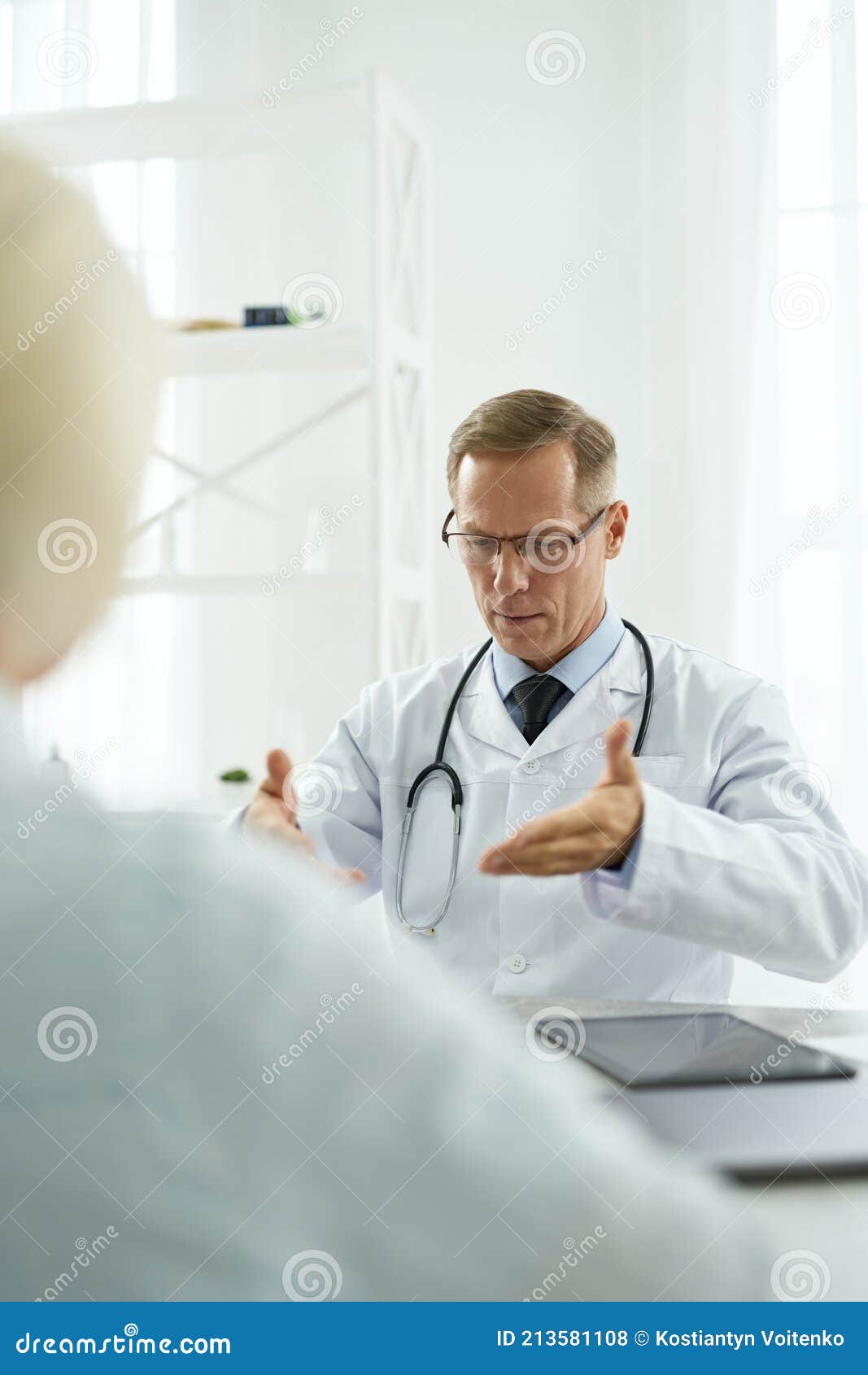 Confused Male Doctor Having Appointment with Patient in Clinic Stock ...