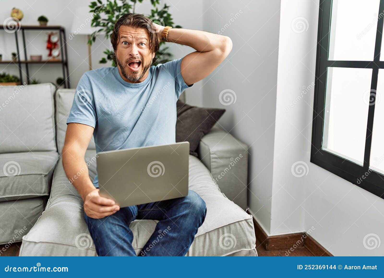Handsome Middle Age Man Using Computer Laptop on the Sofa Crazy and ...