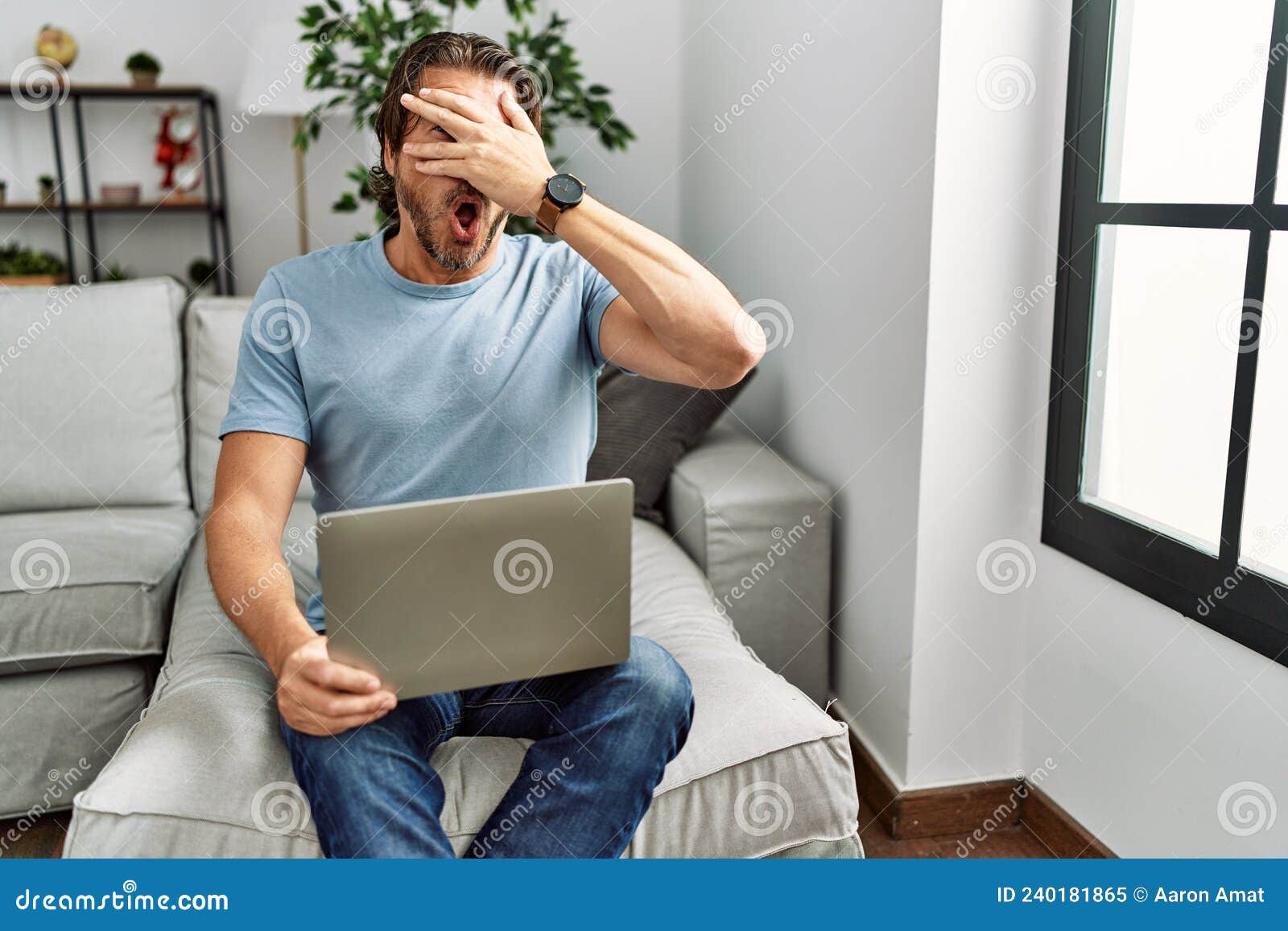 Handsome Middle Age Man Using Computer Laptop on the Sofa Peeking in ...