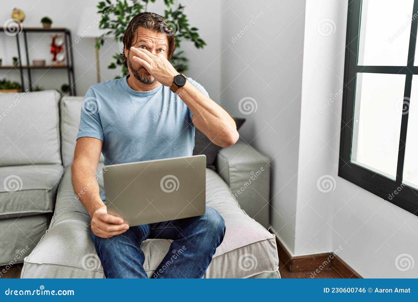 Handsome Middle Age Man Using Computer Laptop on the Sofa Smelling ...