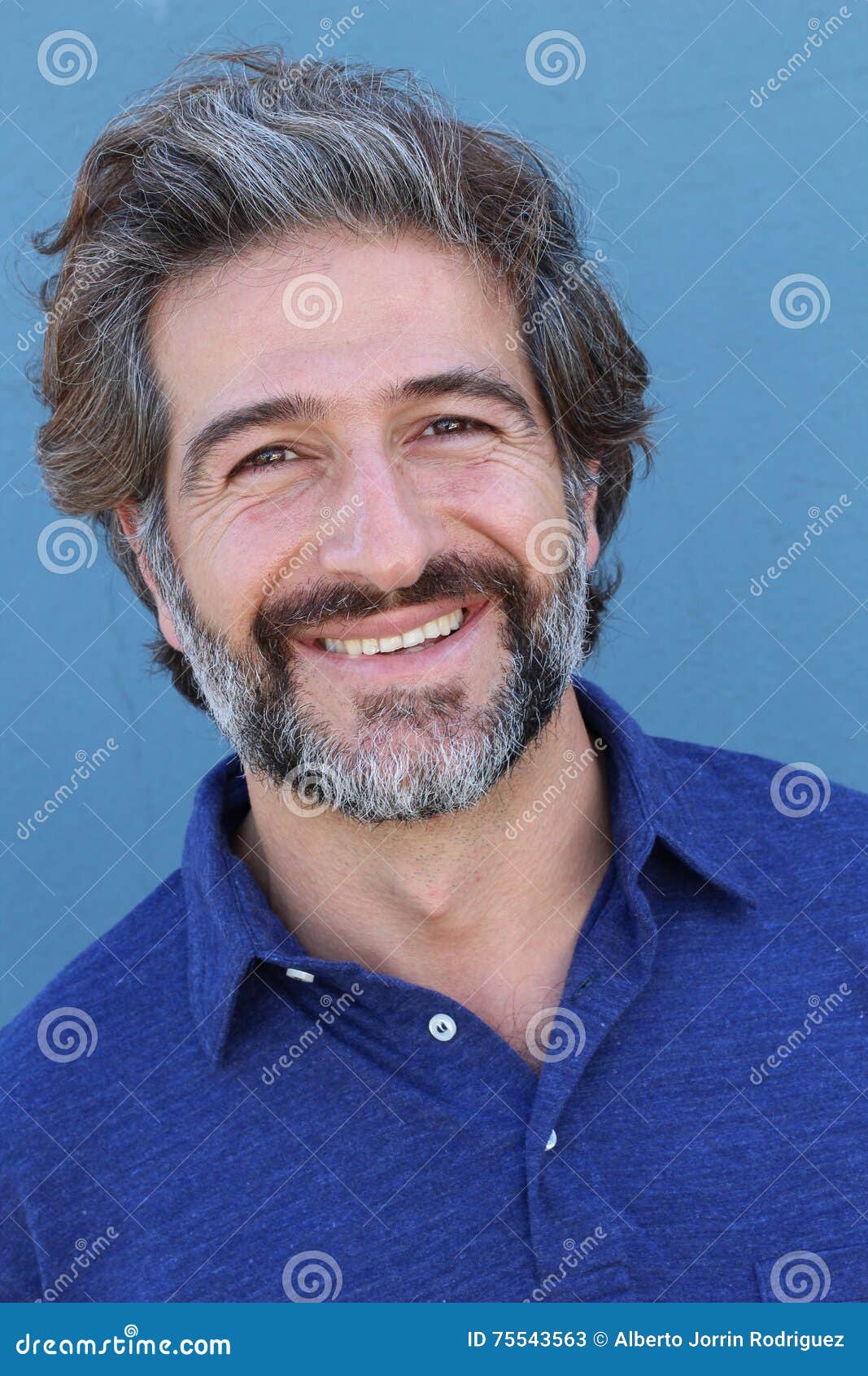 Handsome Middle Age Mediterranean Man in a Studio Portrait on a Blue ...