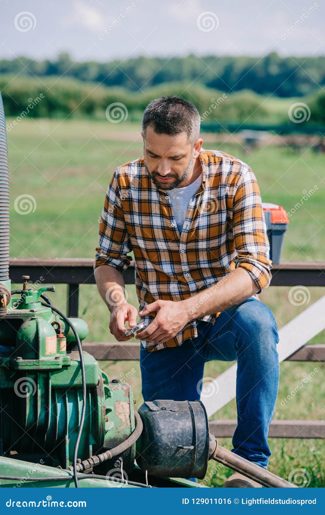Handsome Middle Aged Farmer Repairing Stock Photo - Image of ...