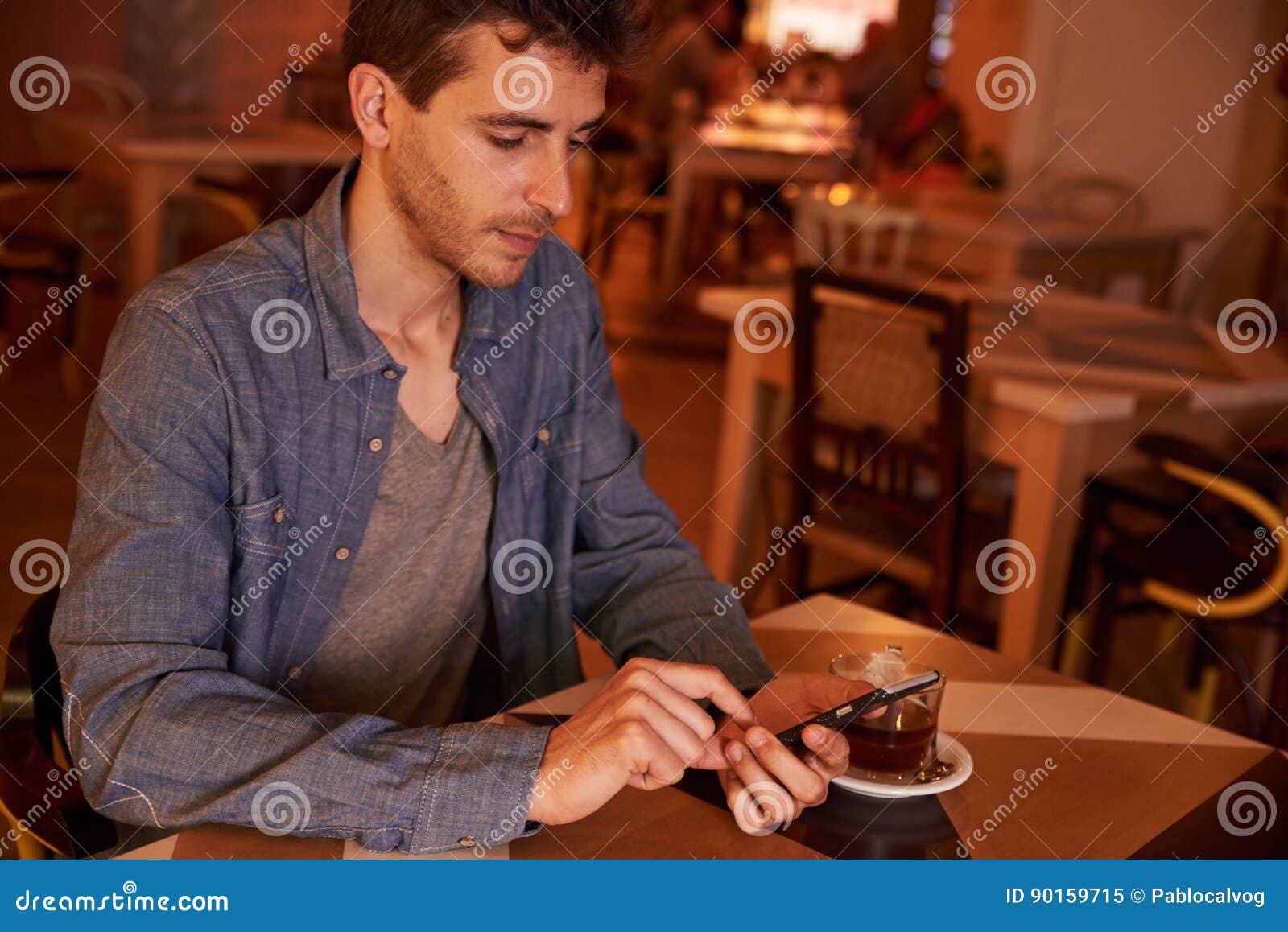 Handsome Millenial Texting in a Restaurant Stock Image - Image of ...