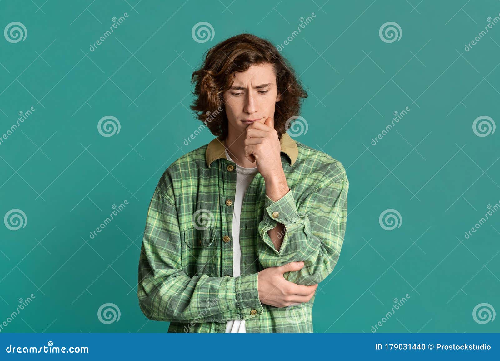 Handsome Millennial Guy Thinking about Something on Turquoise ...