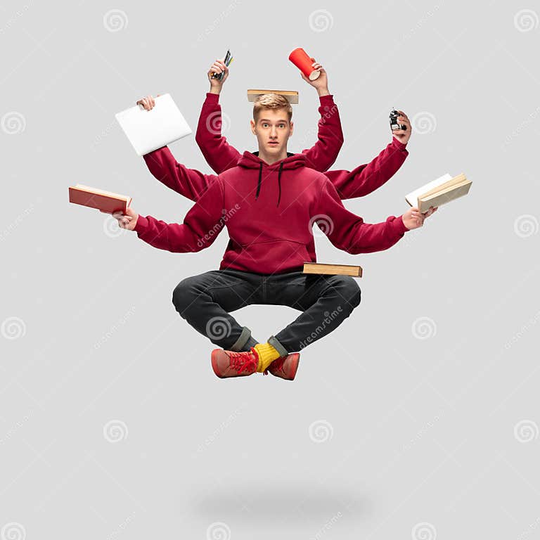 Handsome Multi-armed Student Levitating on Grey Studio Background with ...