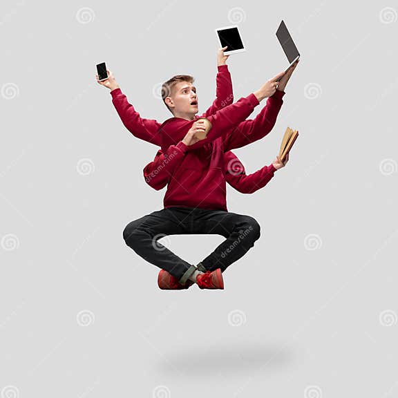 Handsome Multi-armed Student Levitating on Grey Studio Background with ...