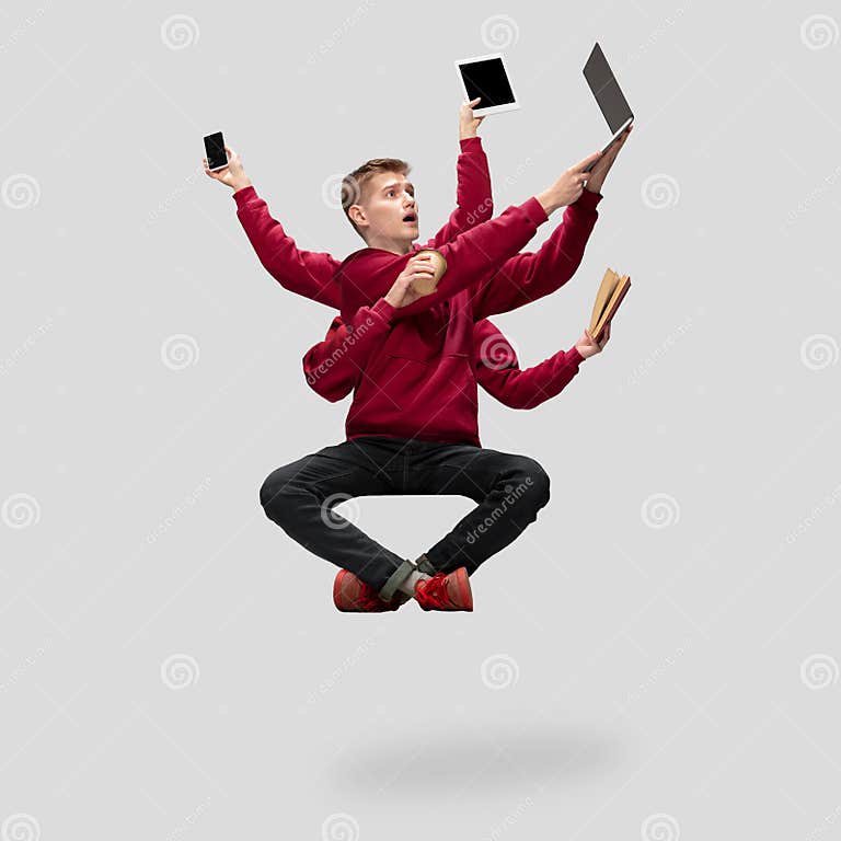 Handsome Multi-armed Student Levitating on Grey Studio Background with ...