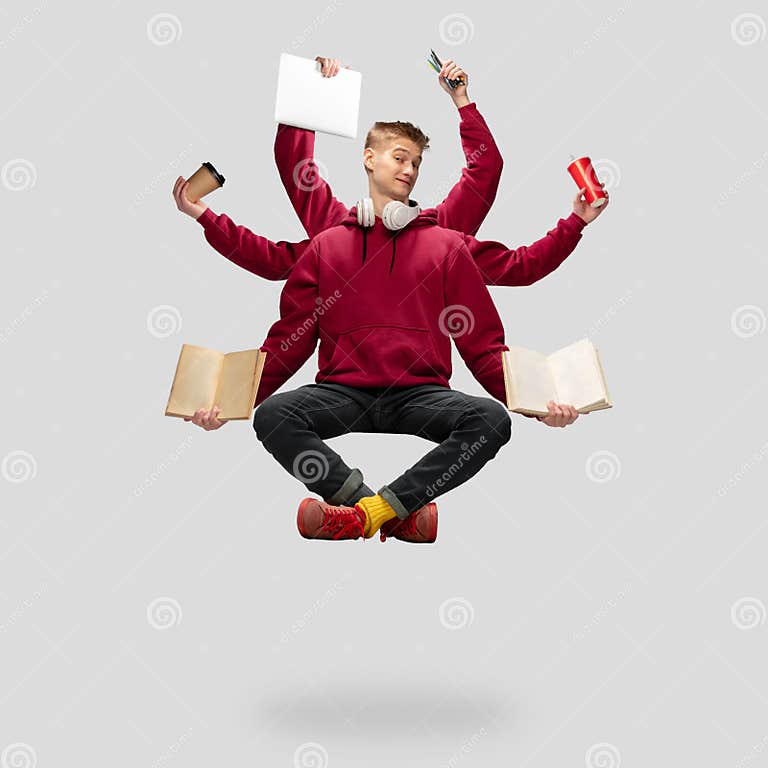 Handsome Multi-armed Student Levitating on Grey Studio Background with ...