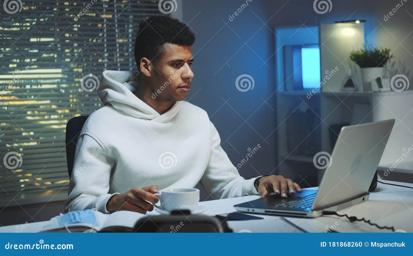 Handsome Multiracial Man Drinking a Cup of Coffee and Working on ...
