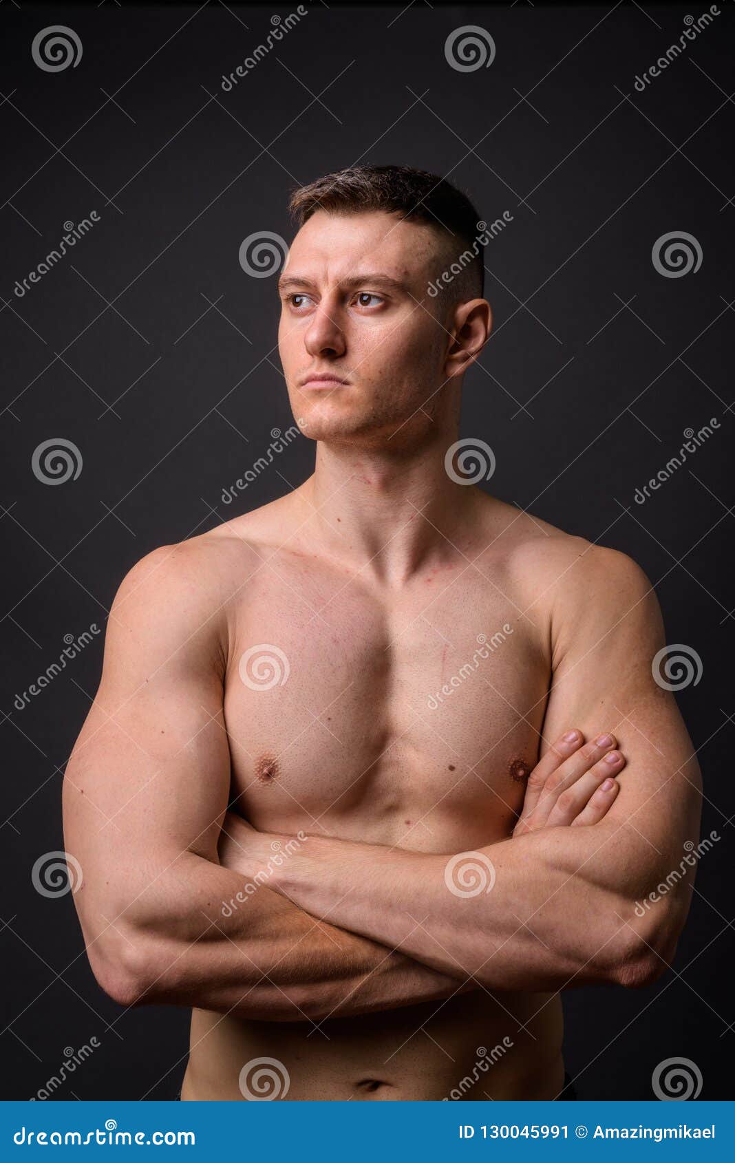 Handsome Muscular Fitness Man Shirtless With Arms Crossed Thinking