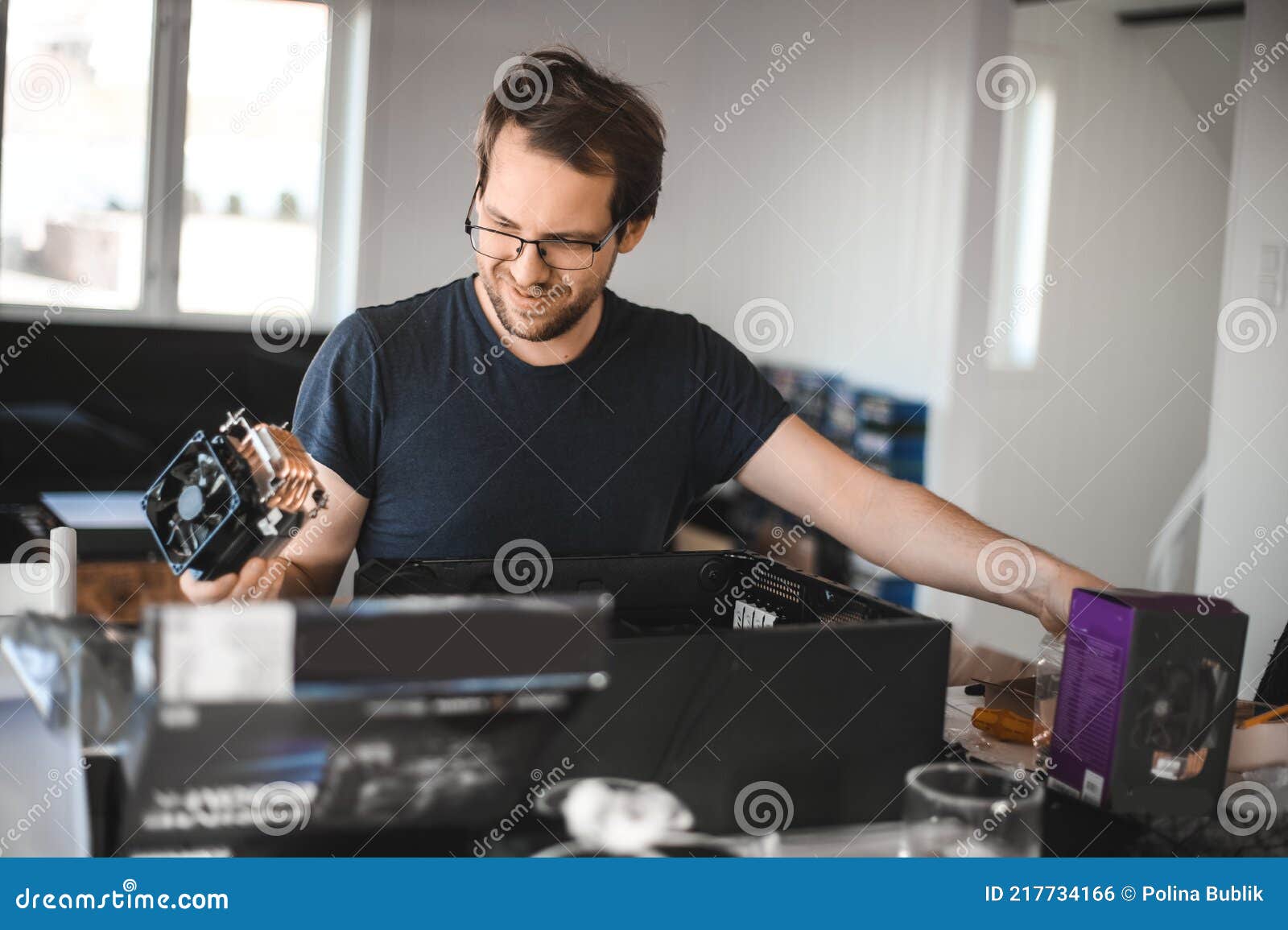 Handsome Nerd Man is Servicing Computer Motherboard and Cooler. Stock ...