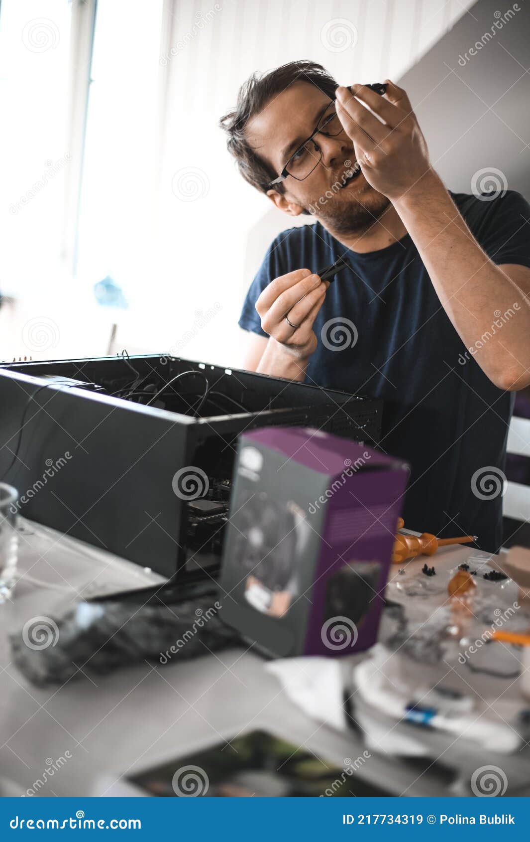 Handsome Nerd Man is Servicing Computer Motherboard and Cooler. Stock ...