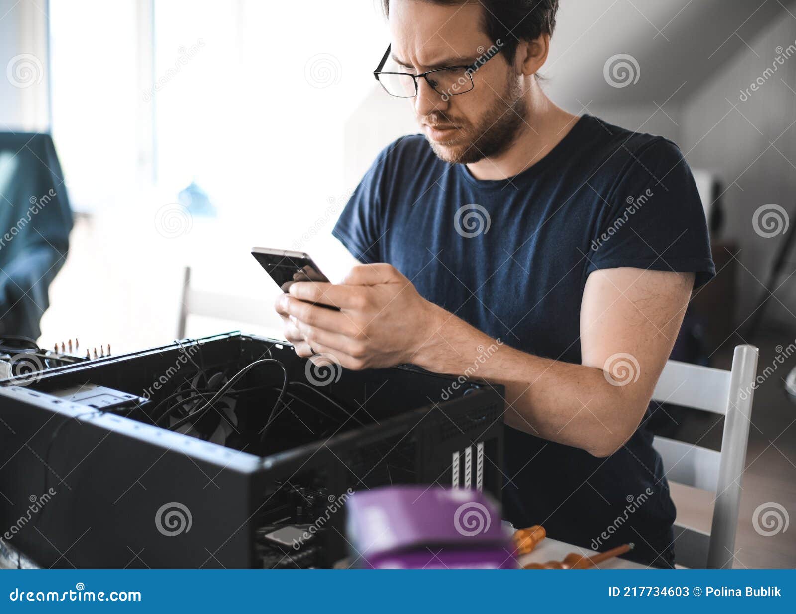 Handsome Nerd Man is Servicing Computer Motherboard and Cooler. Stock ...
