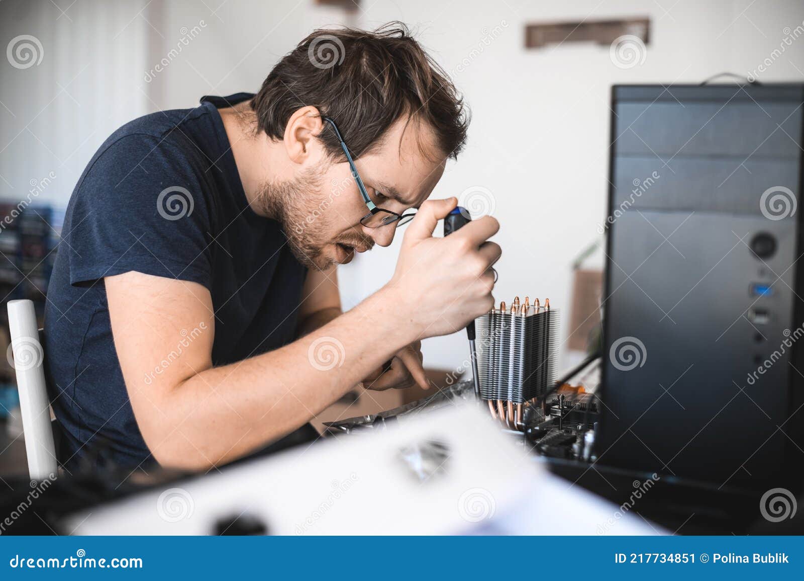 Handsome Nerd Man is Servicing Computer Motherboard and Cooler. Stock ...