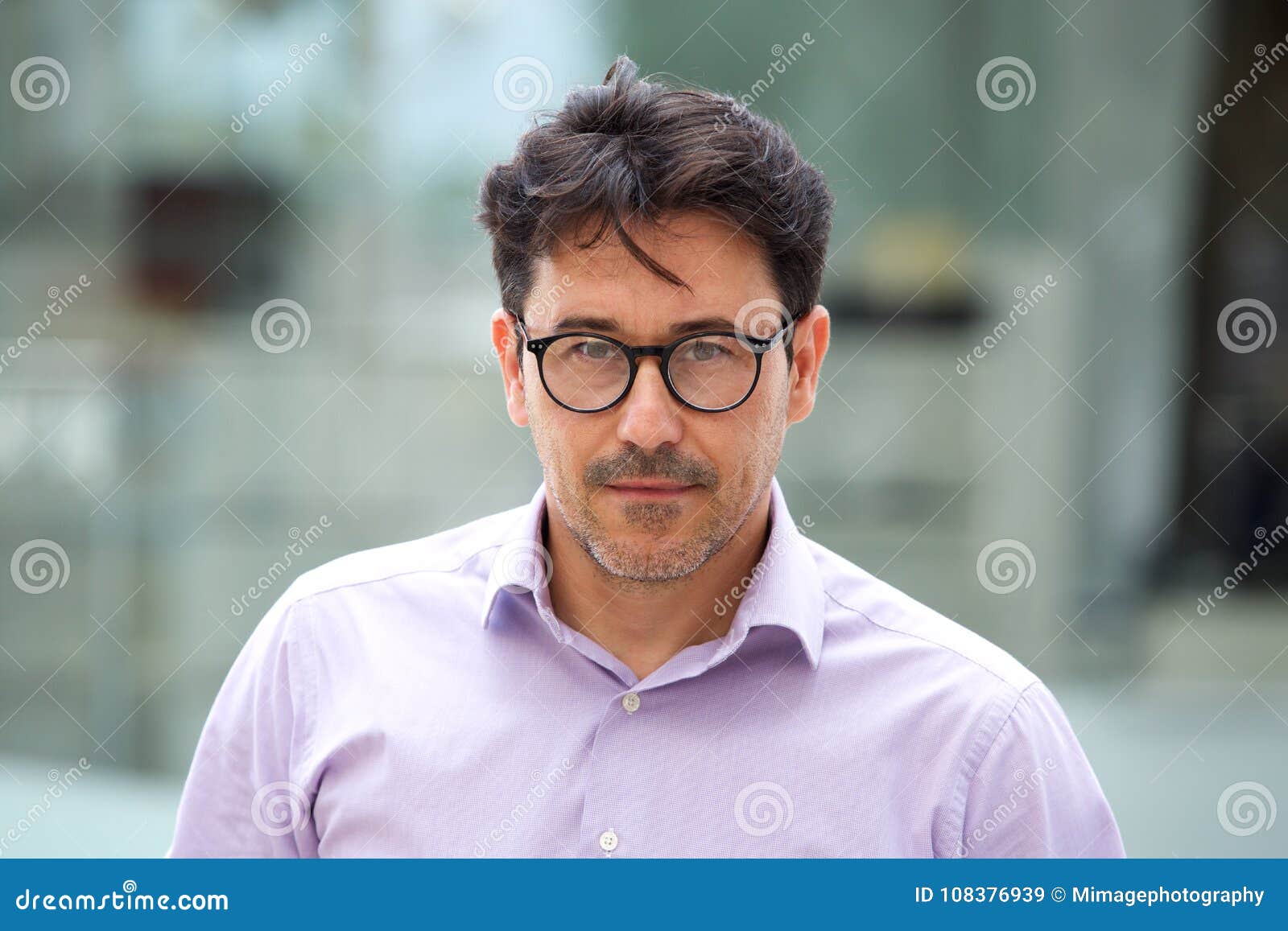 Handsome Older Man With Glasses Standing And Thinking Outdoors Stock