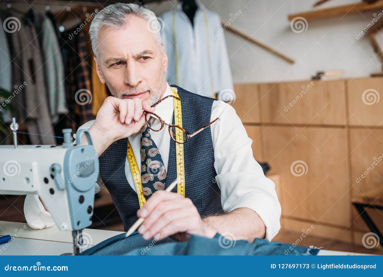 Handsome Pensive Tailor Sitting at Table with Sewing Machine Stock ...