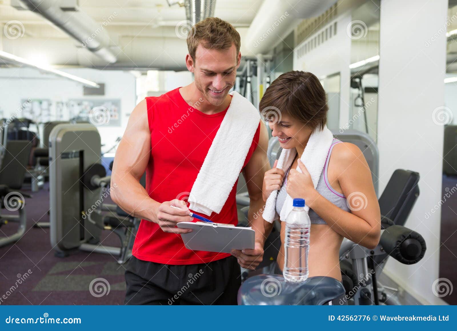 Handsome Personal Trainer with His Client Looking at Clipboard Stock ...