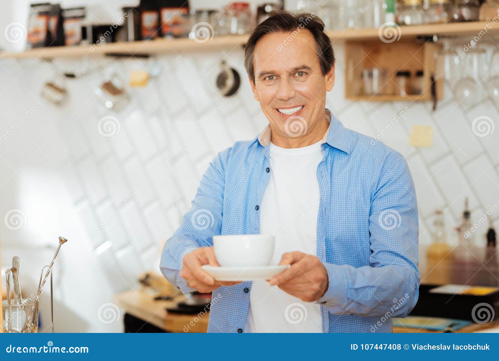Handsome Pleasant Man Smiling and Giving a Cup. Stock Photo - Image of ...