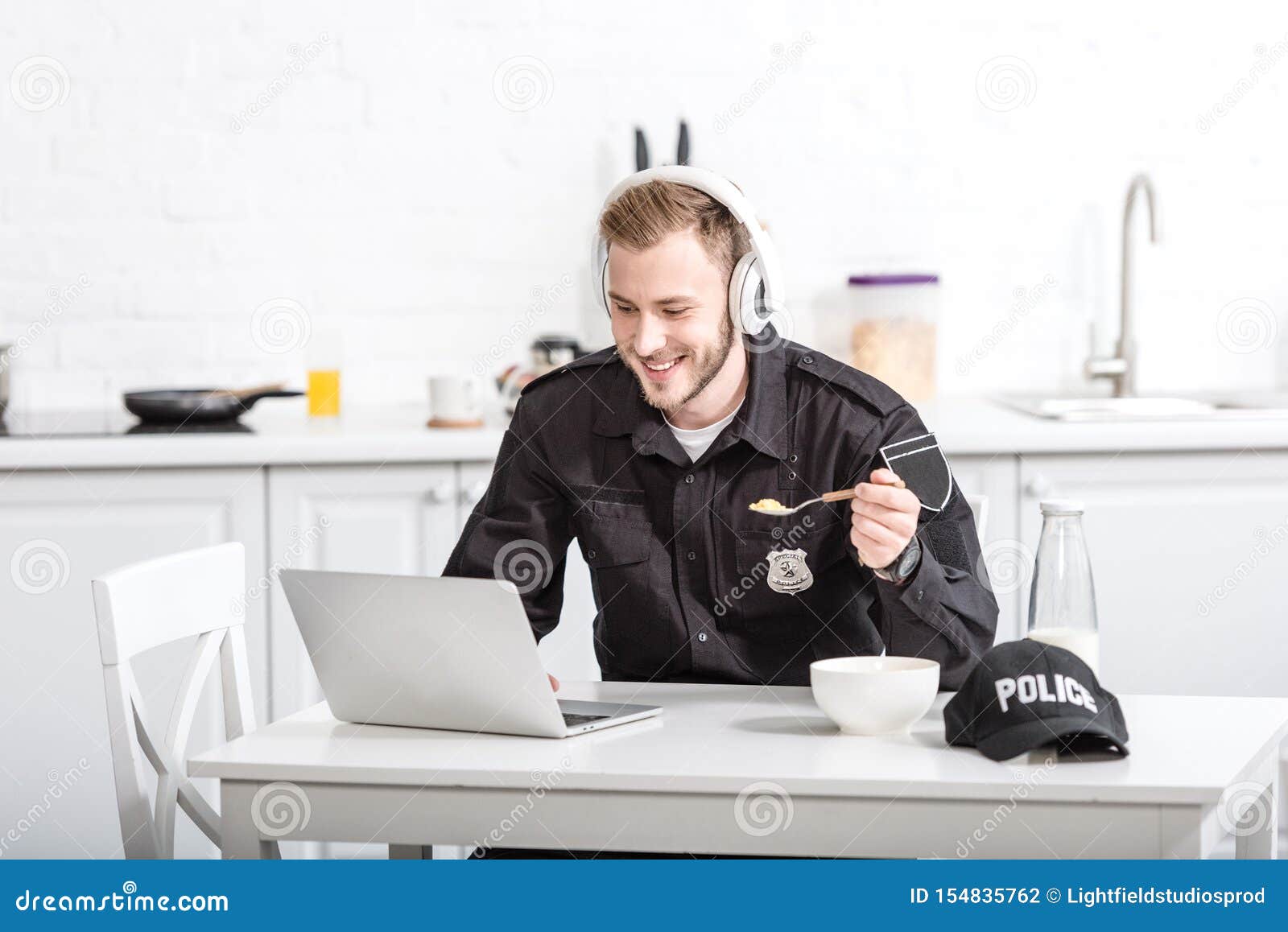 Handsome Police Officer Sitting On Couch And Typing Royalty-Free Stock ...