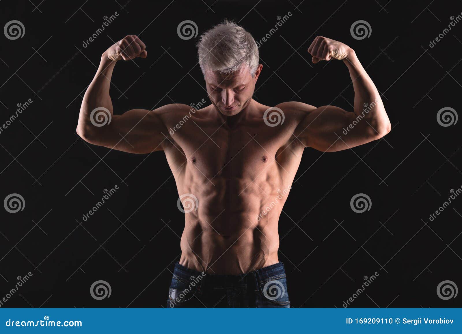 Handsome Power Athletic Man in Dramatic Light. Strong Bodybuilder with ...