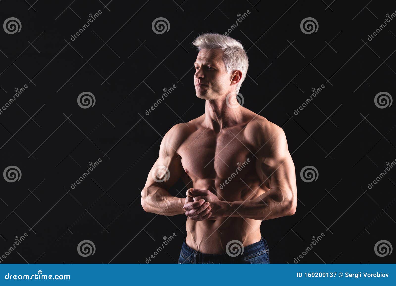 Handsome Power Athletic Man in Dramatic Light. Strong Bodybuilder with ...