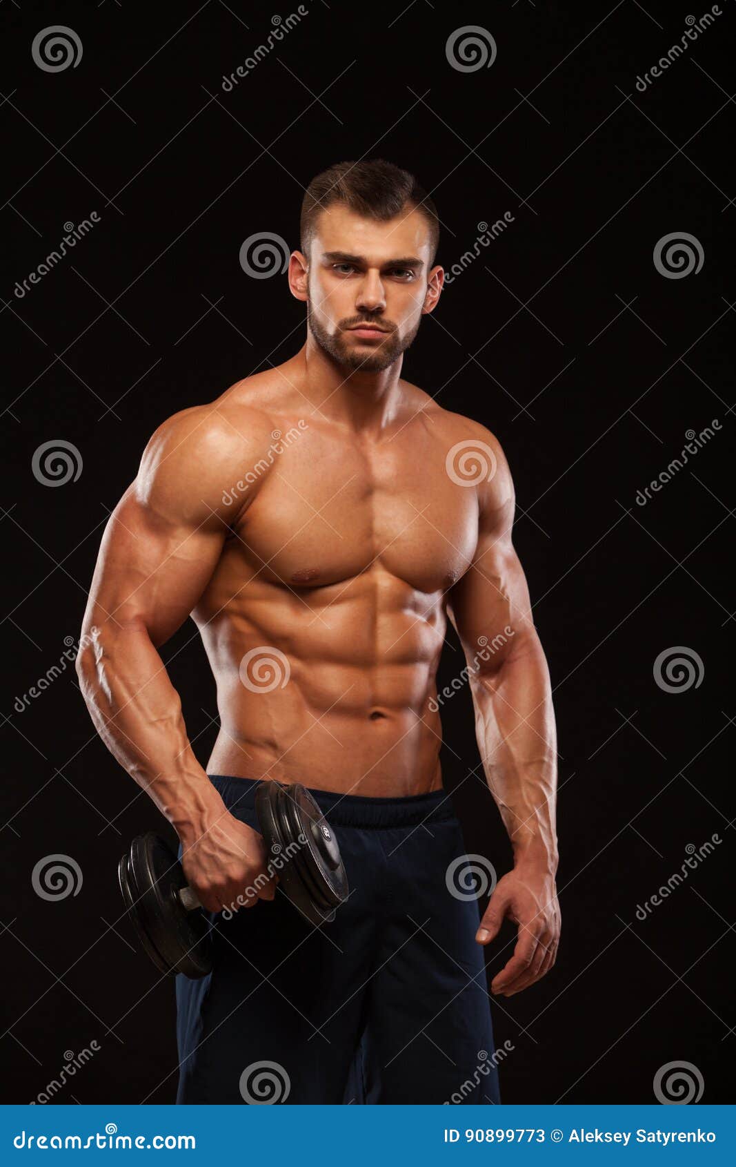 Handsome Power Athletic Man with Dumbbell is Confidently Looking ...