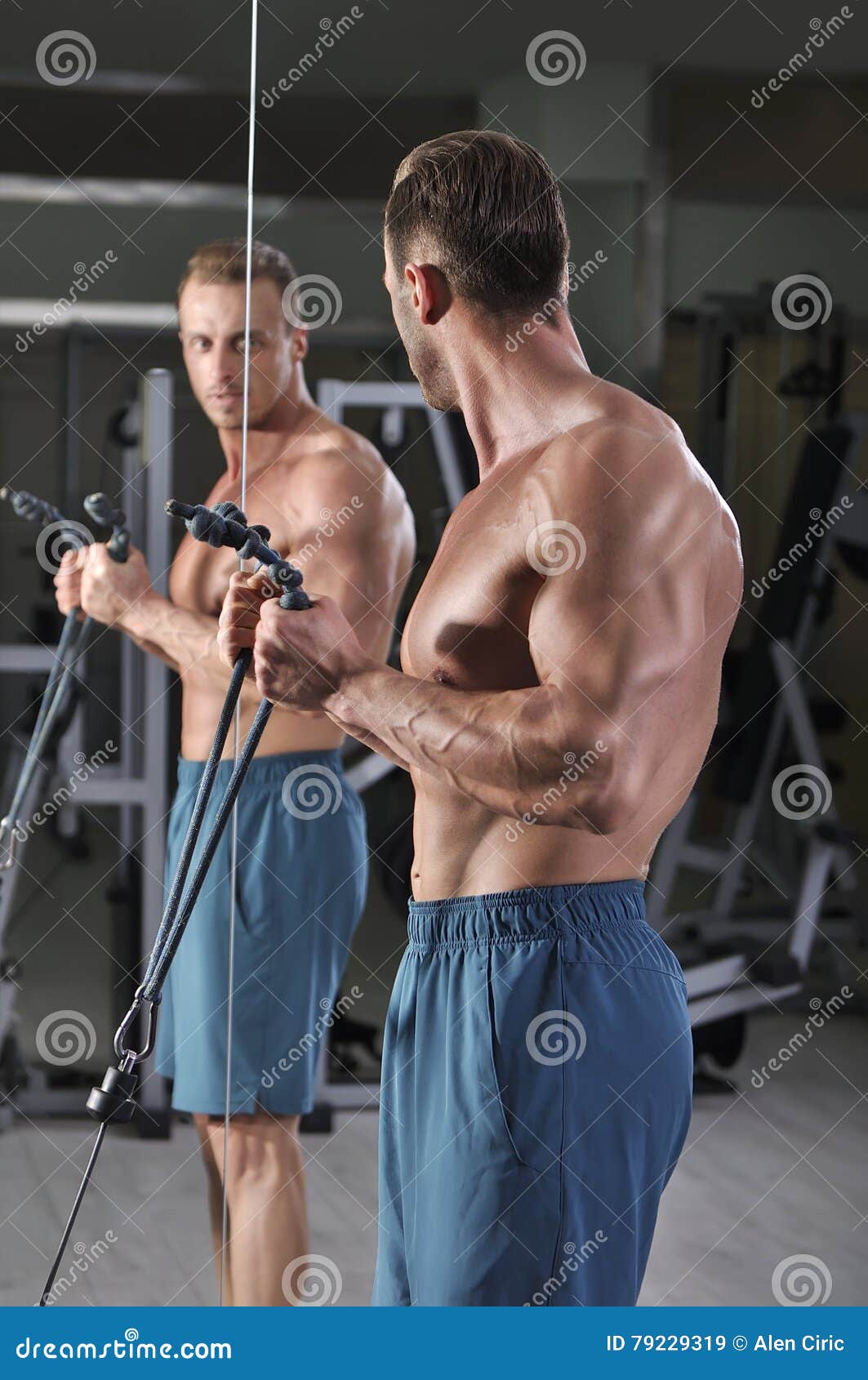 Handsome Powerful Athletic Man Doing Biceps Exercise Stock Image