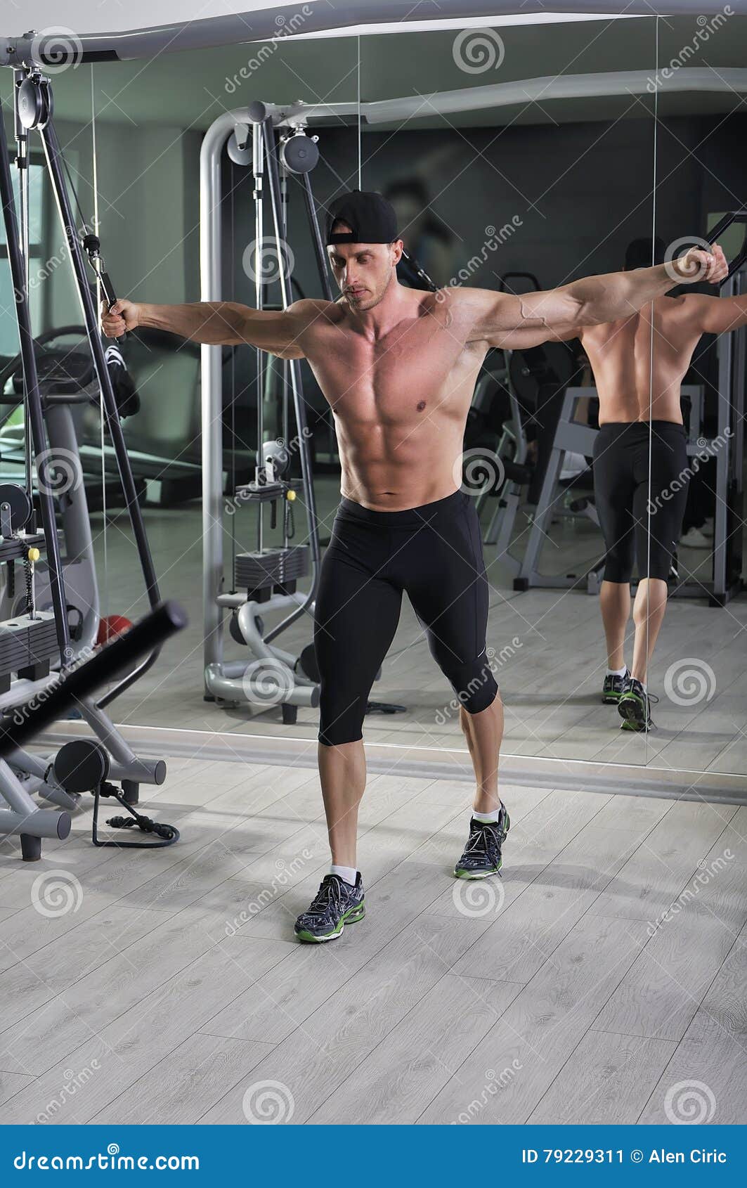 Handsome Powerful Athletic Man Performing Biceps Exercise With Dumbbell