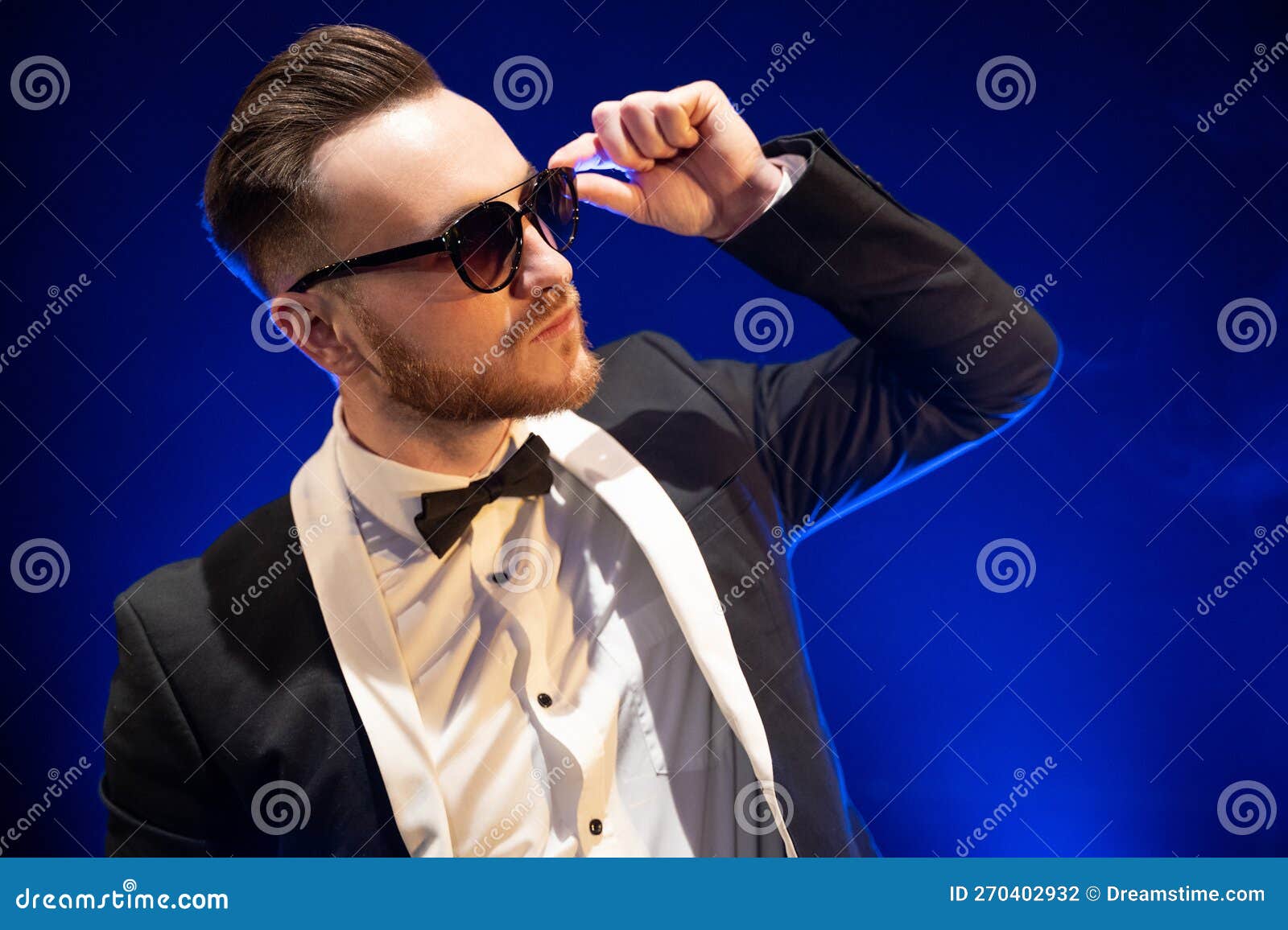 Handsome Presenter and Showman in a Stylish Suit with a Microphone on ...