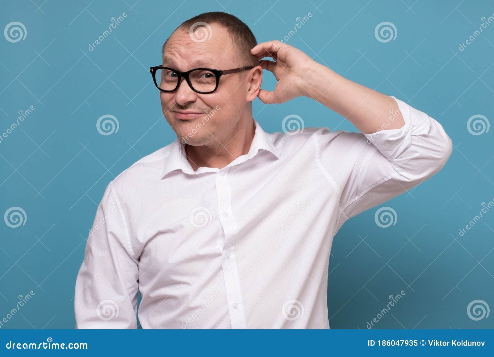 Worker Wearing White Shirt Posing in Studio Full of Doubt and Distrust ...