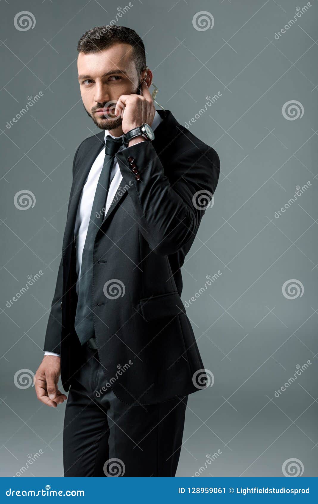Handsome Security Guard Listening Message with Security Earpiece and ...