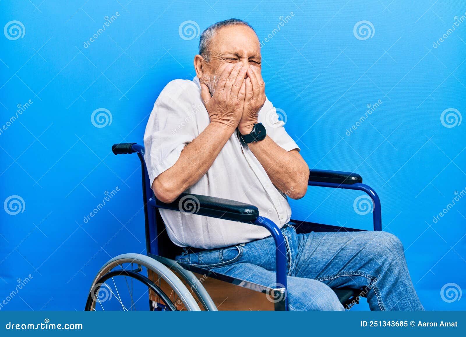 Handsome Senior Man With Beard Sitting On Wheelchair Laughing And