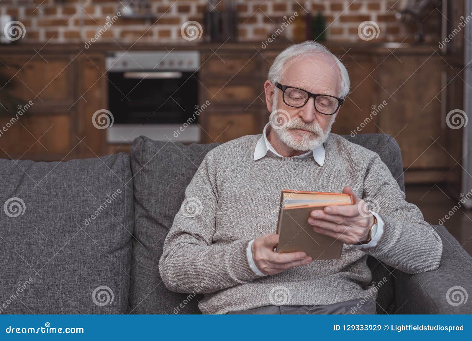 Handsome Senior Man Sitting on Sofa Stock Image - Image of people, male ...