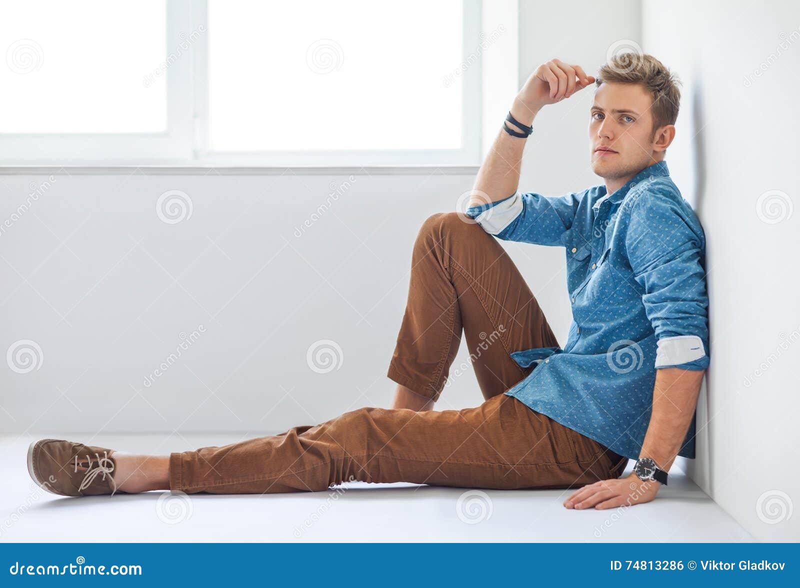 Handsome Serious Man Sitting on the Floor Stock Photo - Image of ...