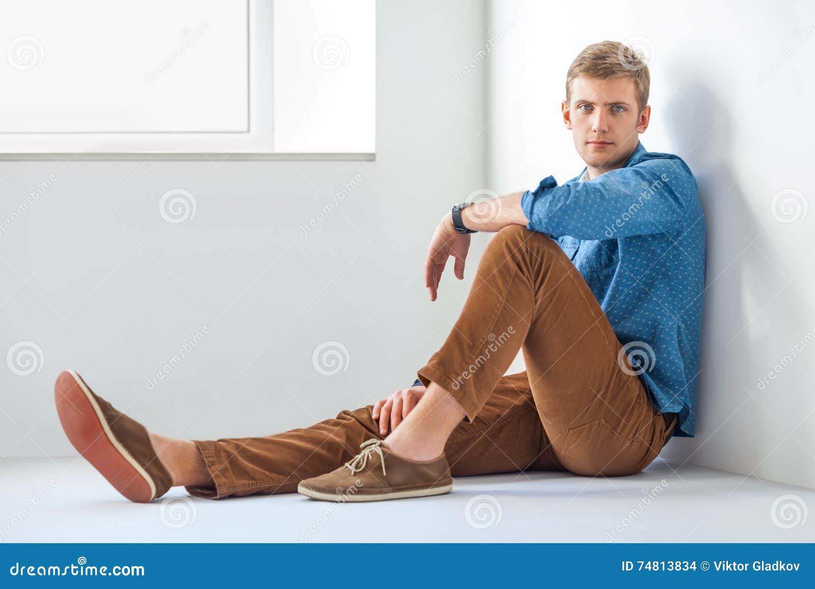 Handsome Serious Man Sitting on the Floor Stock Photo - Image of ...