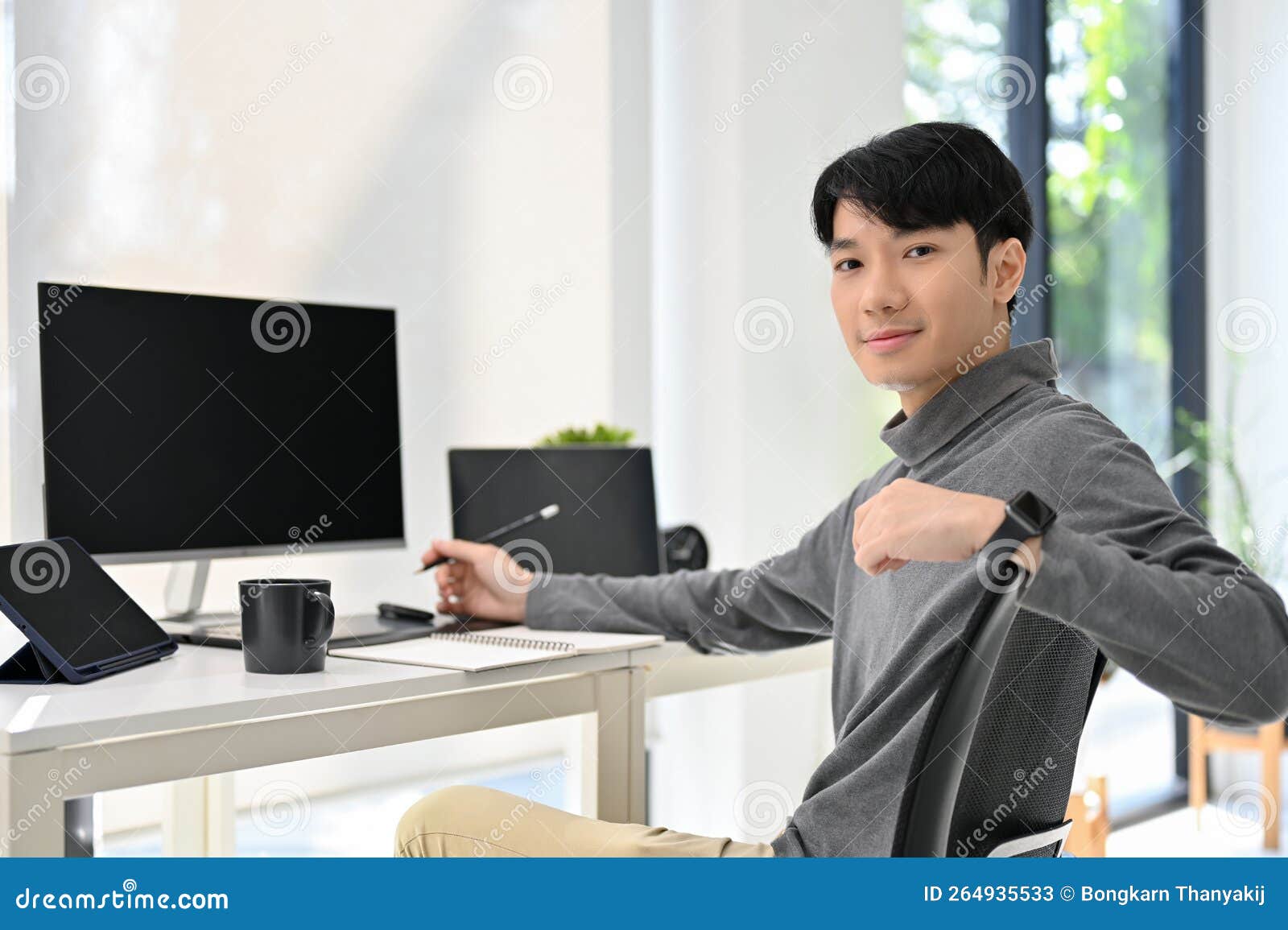 Handsome Asian Male Graphic Designer or Program Developer Sits at His ...