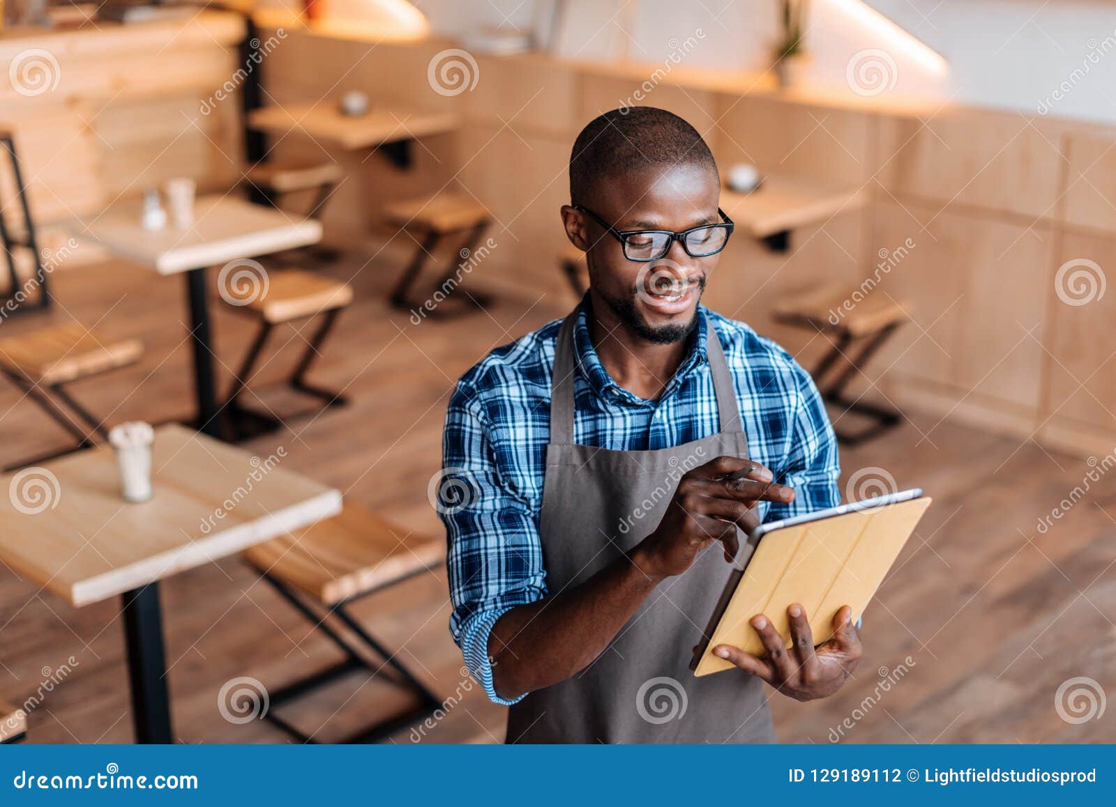 Handsome Smiling African American Waiter Taking Order With Digital