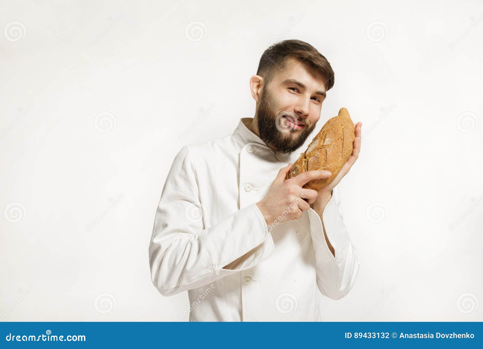 Handsome Smiling BAKER Smelling a Freshly Baked Loaf in the Kitchen of ...