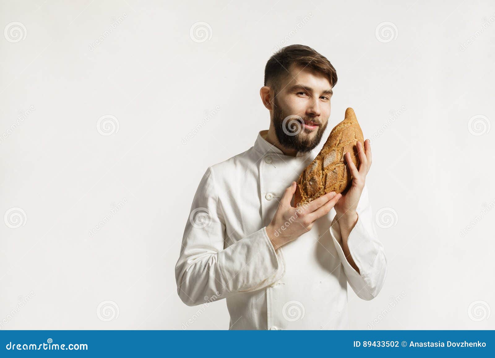 Handsome Smiling BAKER Smelling a Freshly Baked Loaf in the Kitchen of ...