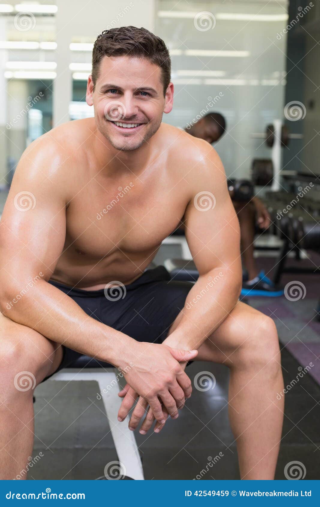 Handsome Smiling Bodybuilder Sitting on Bench in Weights Room Stock ...